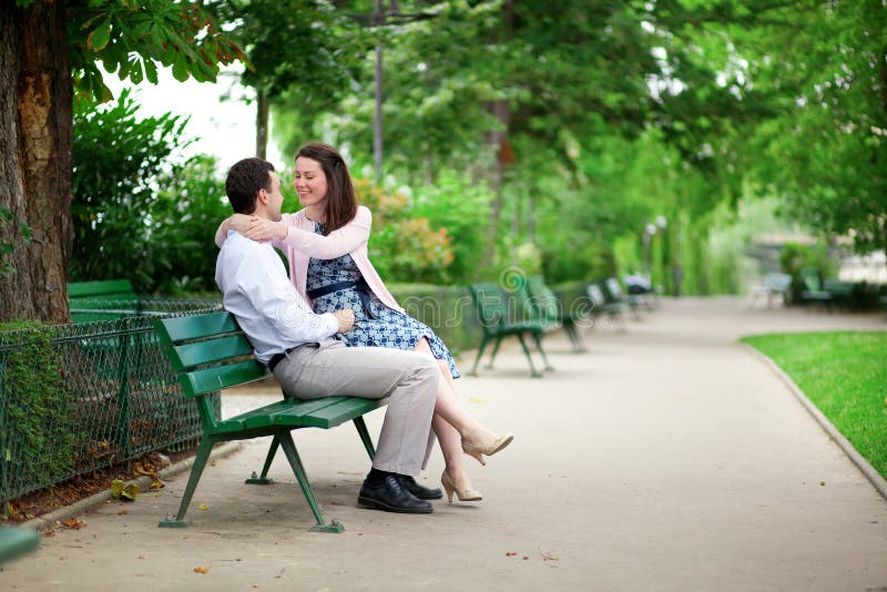 Dating Couple Hugging on a Bench in a Parisian Park Stock Photo - Image ...