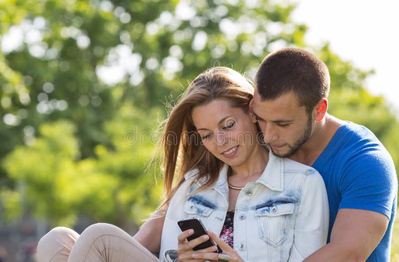 Couple Looking at Cell Phones Stock Image - Image of friendship ...