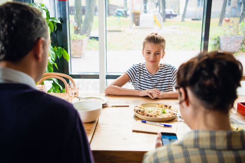 Daughter Chatting with Her Parents at the Table Stock Photo - Image of ...
