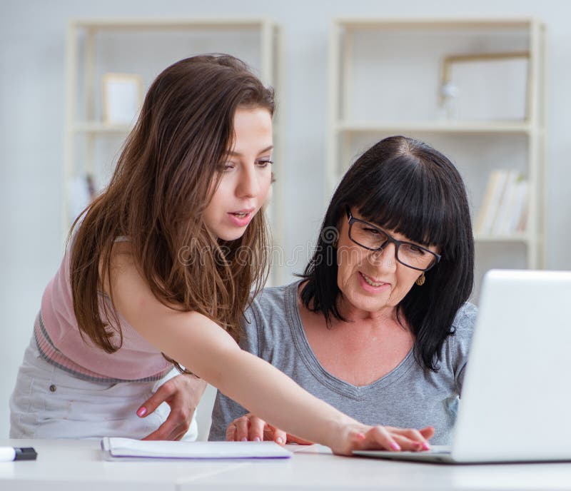 Daughter Explaining To Mom How To Use Computer Stock Photo - Image of ...