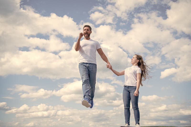 Daughter Hold Her Inspired Father Jumping in Sky Stock Image - Image of ...