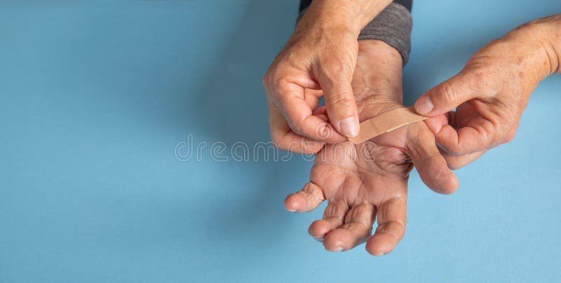 Daughter Putting Adhesive Bandage on Elderly Mother Hand Stock ...