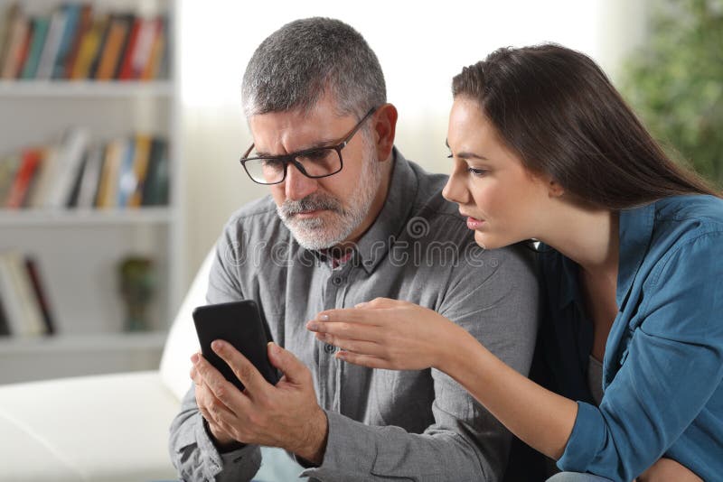 Daughter Teaching How To Use a Phone To Her Father Stock Image - Image ...