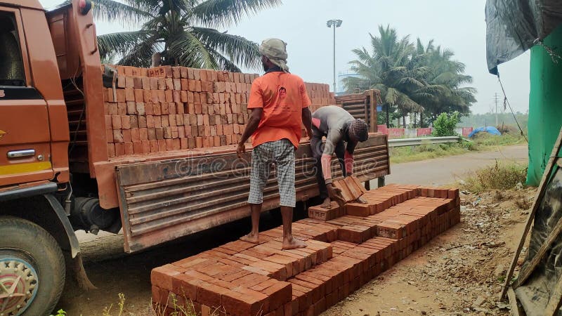 Unloading Bricks at a Construction Site Using a Crane and Workers ...