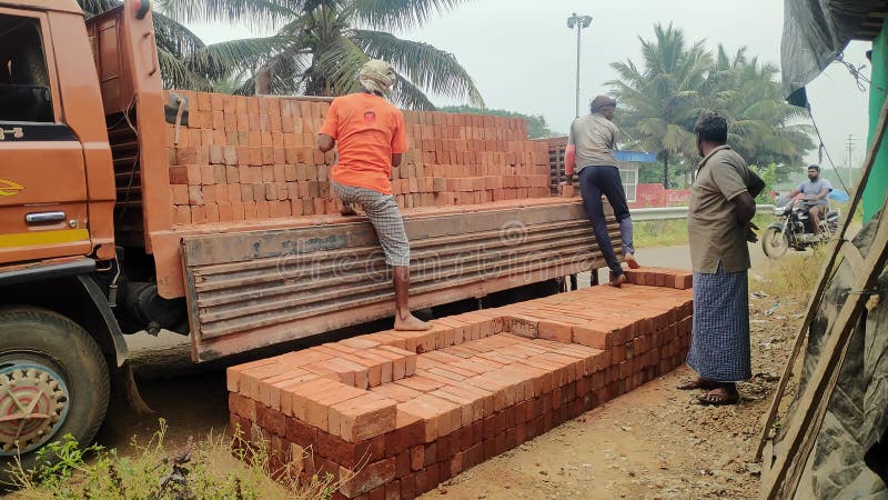 Indian Workers Unloading Red Bricks from the Lorry Trolley at ...