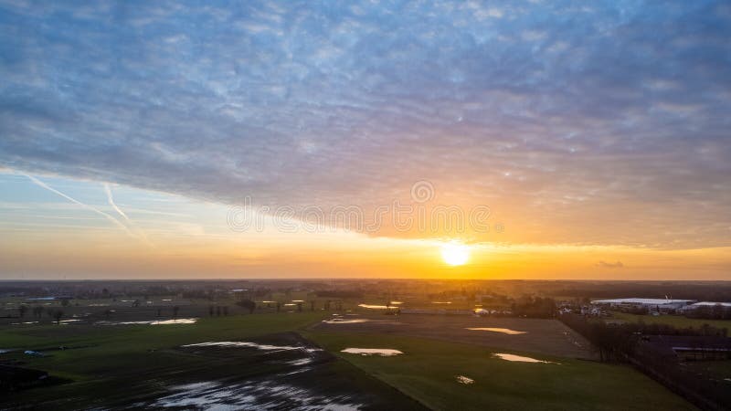 Dawn Breaking Over Wet Fields with Cloudy Sky Stock Image - Image of ...