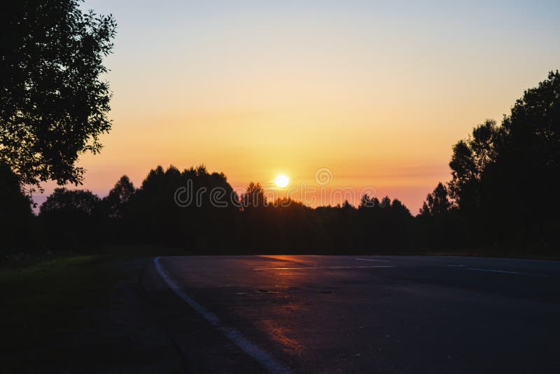 Dawn Over the Road Leading Towards the Dark Forest Stock Image - Image ...
