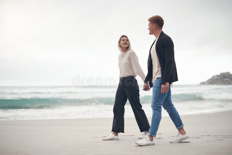 A Day at the Beach is Just What we Needed. a Couple Holding Hands while ...