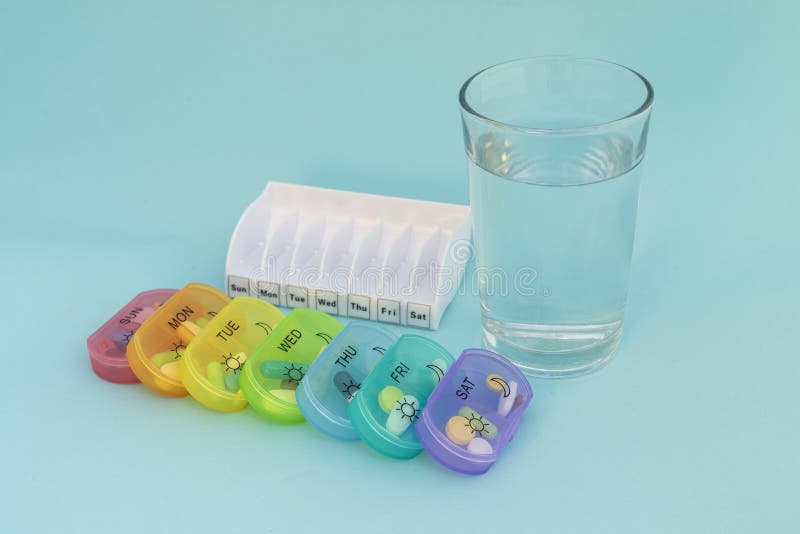 7 Day Pill Organizer with a Glass of Water Stock Image - Image of ...