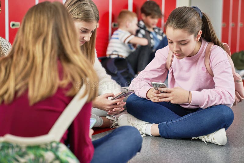 Two Students Texting in Their Smart Phones in a Park Stock Photo ...