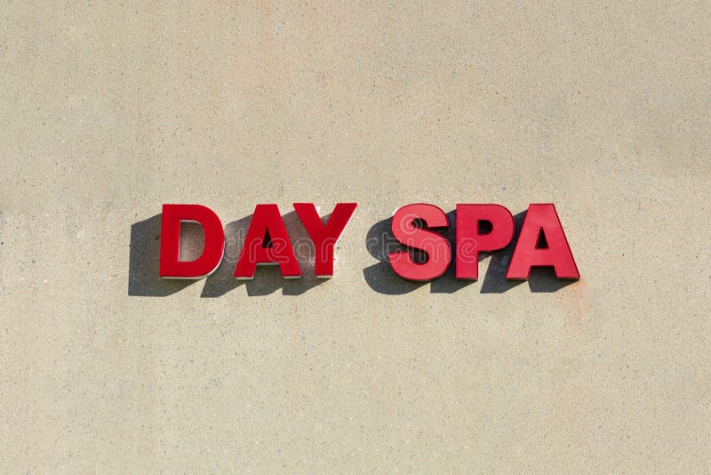Day Spa Sign Logo in Red Letters on Beige Concrete Wall Stock Image ...