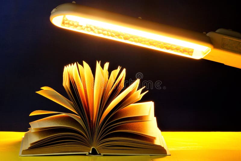 Daylight Lamp, Illuminates the Book on the Table in the Dark. Stock ...