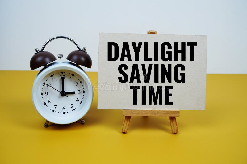 Daylight Saving Time Text on Paper Card with Alarm Clock on Yellow ...