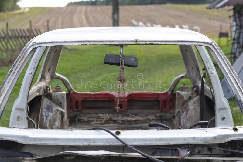 Daylight. Unassembled White Car. There is a Wooden Cross in the Center ...