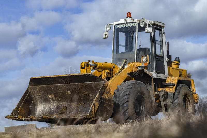 Daylight Yellow Loader with a Bucket. There is a Tint Stock Photo ...