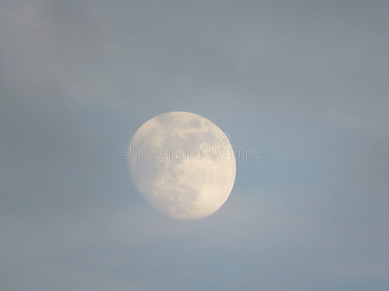 Daytime moon behind clouds stock photo. Image of daytime - 270622920