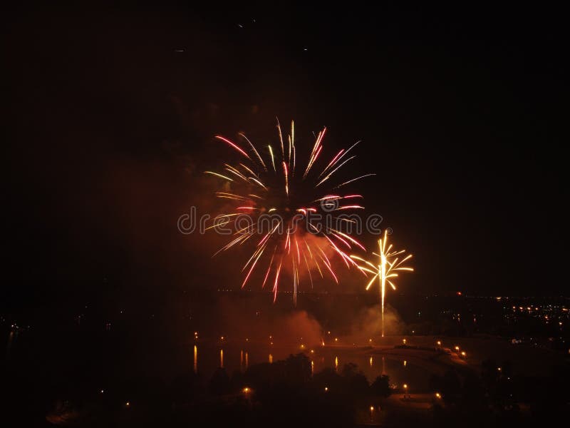 Fireworks Exploding Over a City at Night, with Lights on Stock Photo ...
