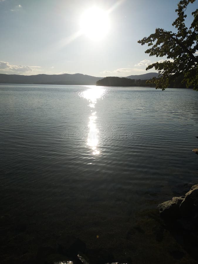 The Dazzling Sun at Sunset Over the Lake Stock Image - Image of ...