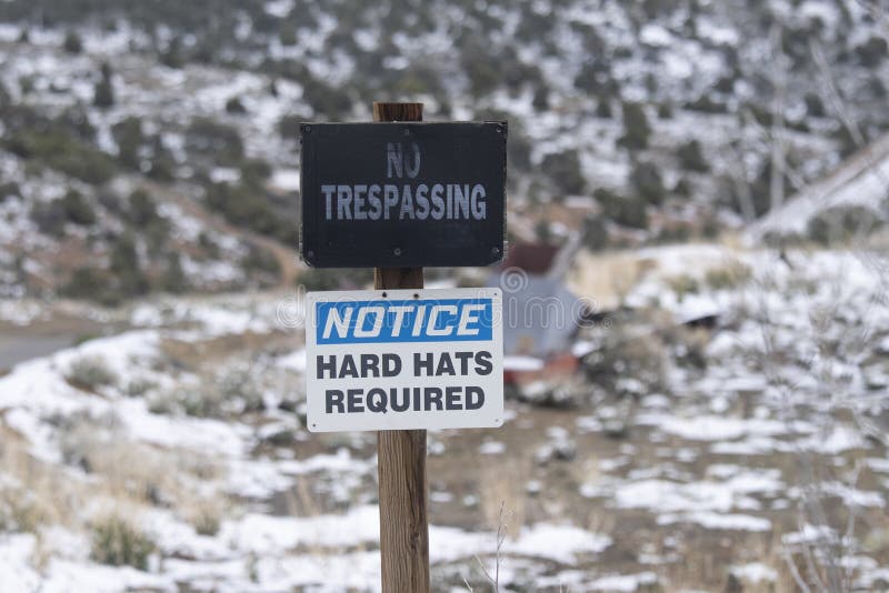 No Trespassing and Hard Hats Required Sign in Snowy Terrain Stock Photo ...