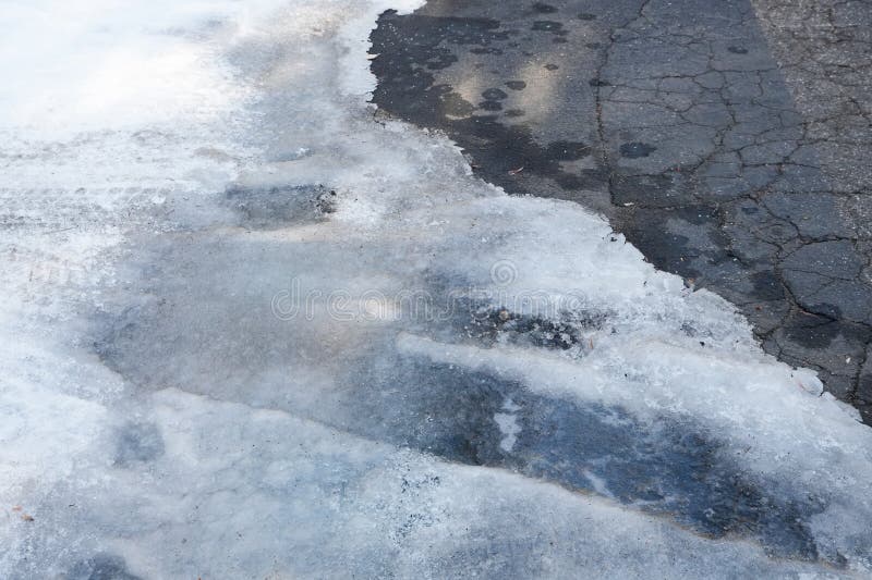 Ice and Dry Pavement with Tire Tracks at Edge of Road Stock Image ...