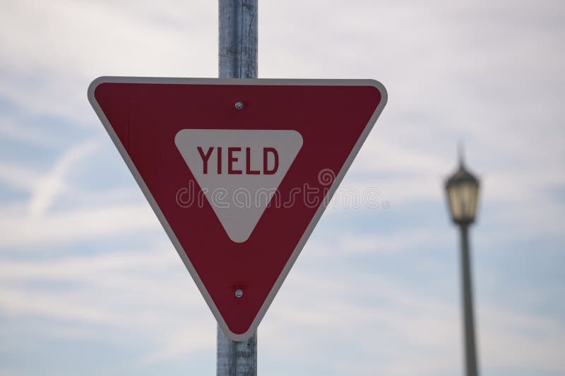 Yield Sign with Streetlamp in Background Stock Photo - Image of brand ...
