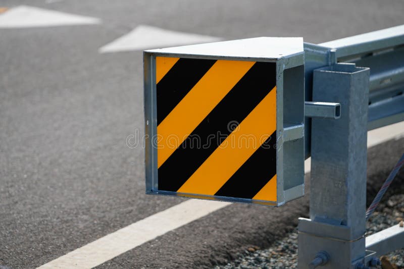 Black and Yellow Striped Road Hazard Marker on Guardrail Stock Image ...