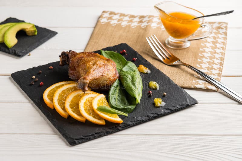 Duck Leg Served with Spinach and Orange Sauce Stock Photo - Image of ...