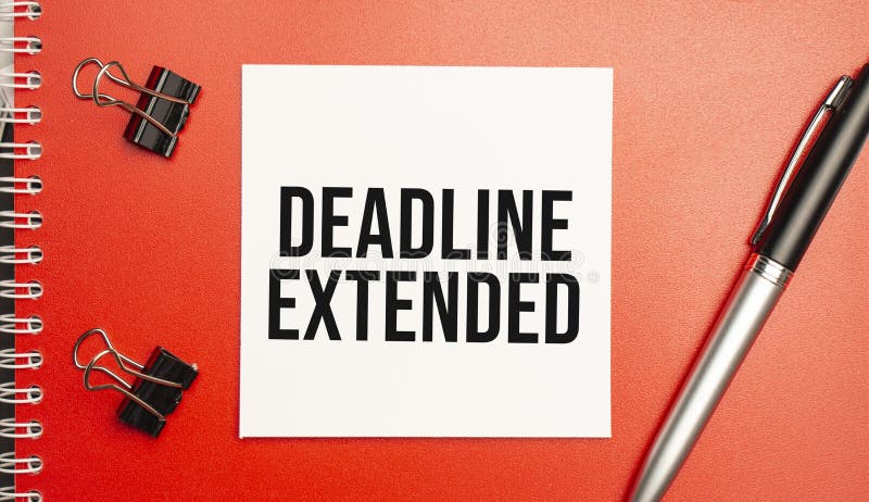 DEADLINE EXTENDED Sign on Sheet of Paper on the Red Notepad with Pen ...