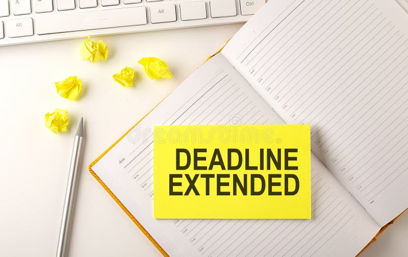 DEADLINE EXTENDED Text on Sticker on the Diary with Keyboard and Pencil ...