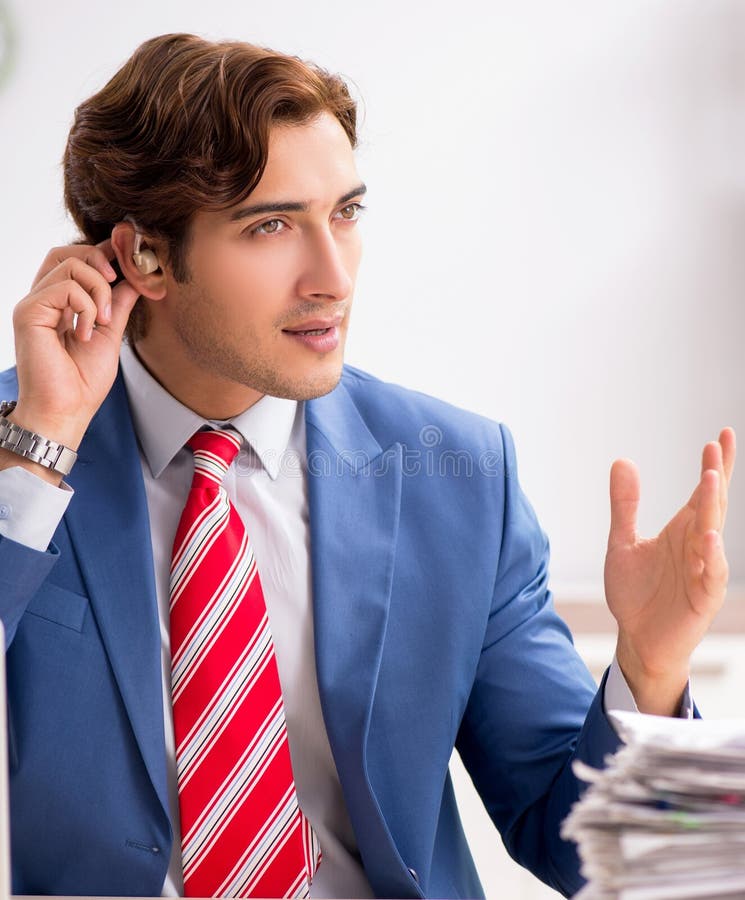Deaf Employee Using Hearing Aid in Office Stock Image - Image of ...