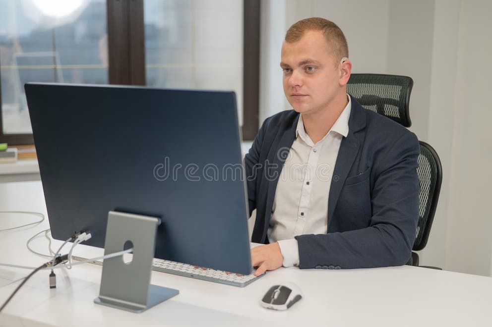 Deaf Man Working on a Computer in the Office. Stock Image - Image of ...
