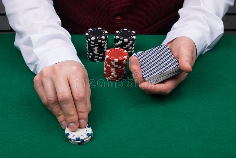The Dealer`s Hands are Holding a Deck of Cards and Placing Chips on the ...
