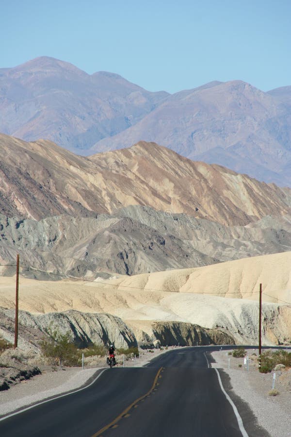 Death Valley Empty Road with Lone Cyclist Stock Photo - Image of death ...