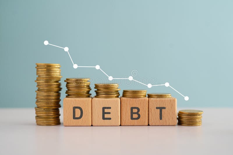 DEBT Text on Wooden Cube Blocks Word and Down Arrow with Stack of Coins ...