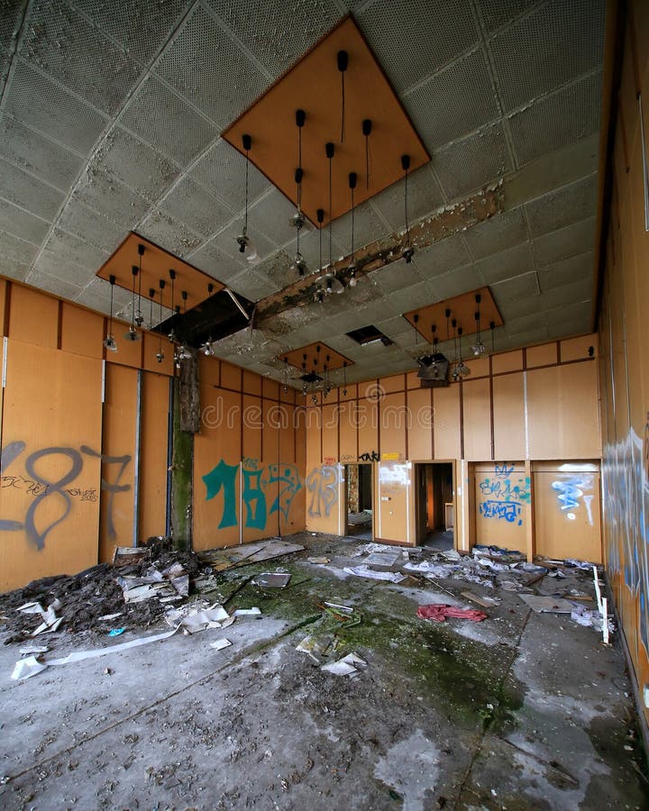 Decay and Debris in an Abandoned Room with Broken Ceiling Panels, Graffiti, and Scattered Papers ...