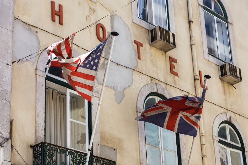 Decayed Old Hotel with US and United Kingdom Flags in Front Stock Photo ...
