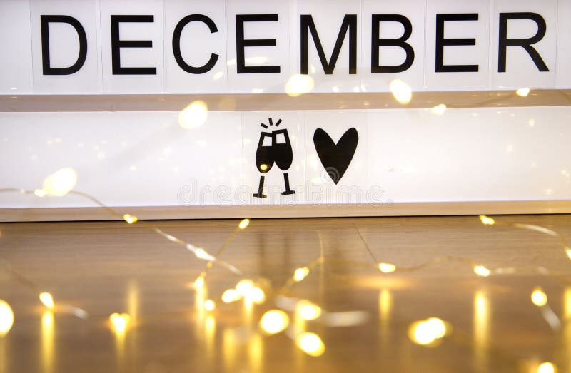 December Sign with Led Lights and Reflections on Wood Stock Image ...