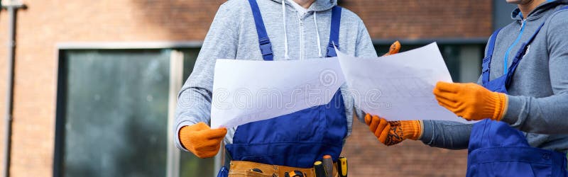 Decision Making. Two Positive Builders Smiling while Standing Outdoors ...