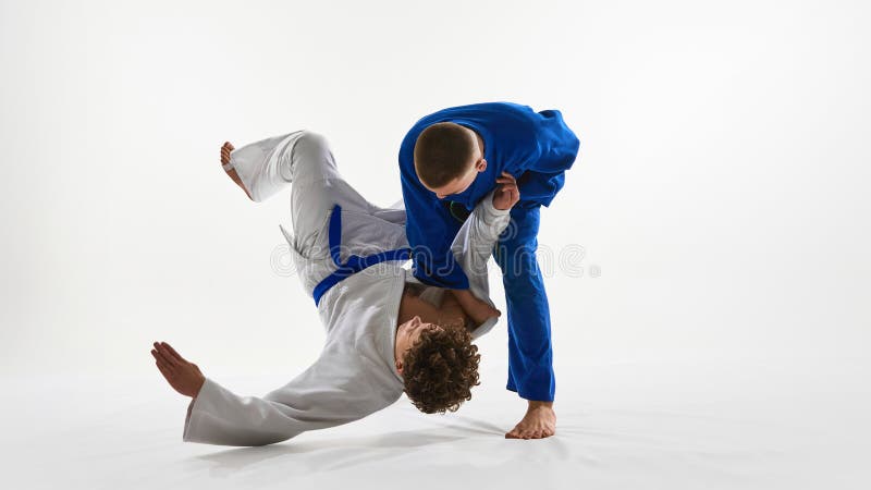 Decisive Hip Throw Unfolding, White Gi Athlete Launches Opponent in ...