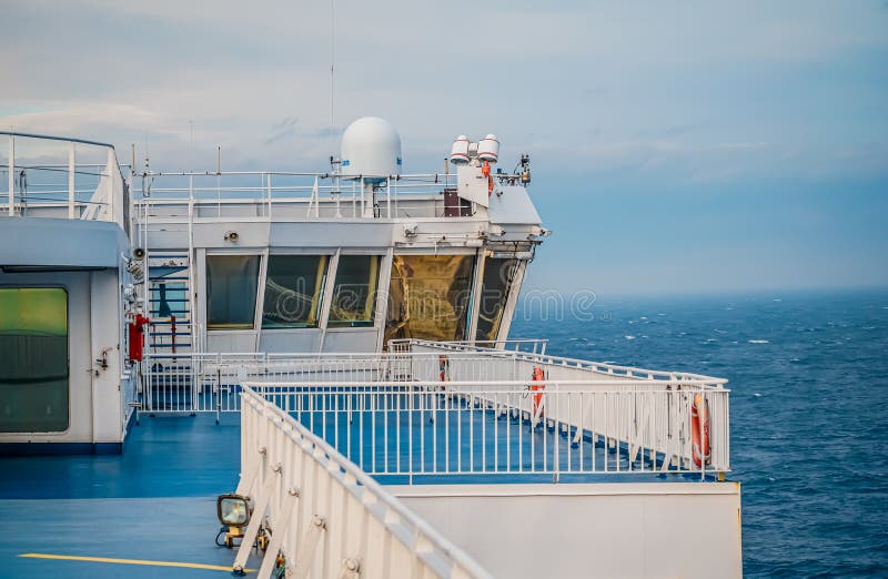 The Deck Area of an Expansive Large Ship Featuring a White Railing ...