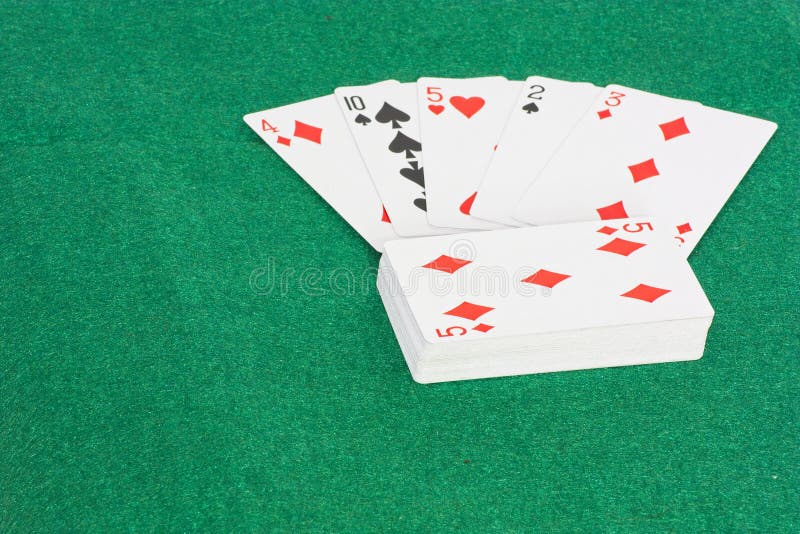 A Deck of Cards Laid Out on a Green Background Stock Image - Image of ...