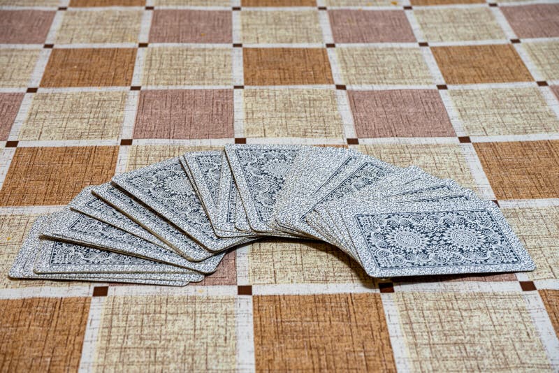 Deck of Cards Spread Out on a Table with a Checkered Tablecloth Stock ...