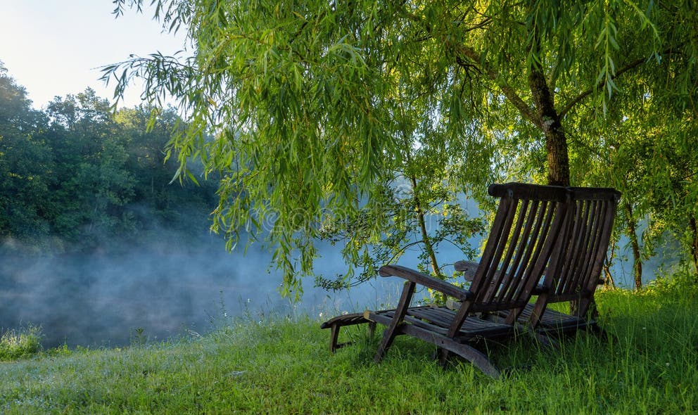 Deck Chair at the Edge of the Pond at Sunrise Stock Image - Image of ...