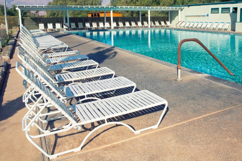 Deck Chairs and Swimming Pool Stock Photo - Image of lounge, swimming ...