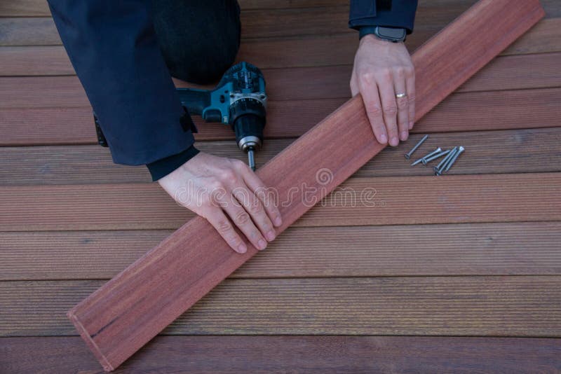 Deck Installation Carpenter Hands Holding Ipe Board Stock Image - Image ...