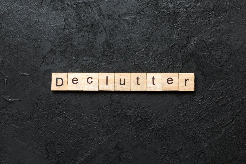 Declutter Word Written on Wood Block. Declutter Text on Cement Table ...
