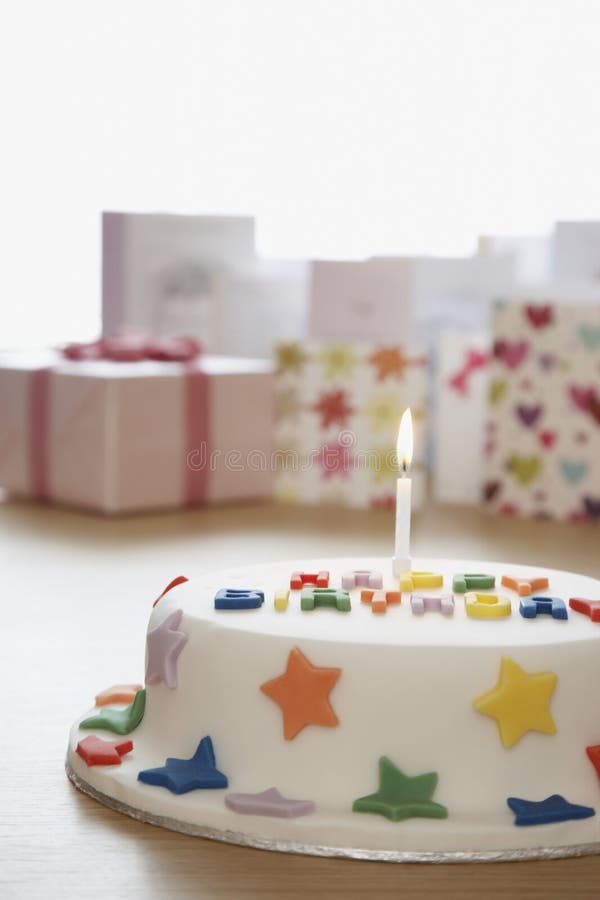 Decorated Birthday Cake with Candle in Front of Cards in Studio Stock ...