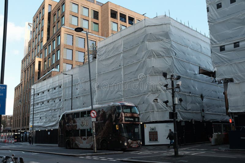A Decorated Bus Passing by a Building Under Construction, Shoreditch ...