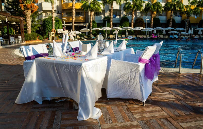 Decorated Dining Table with White Clothes and Ribbons before Pool in an ...
