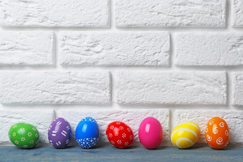 Decorated Easter Eggs on Table Near Brick Wall Stock Image - Image of ...